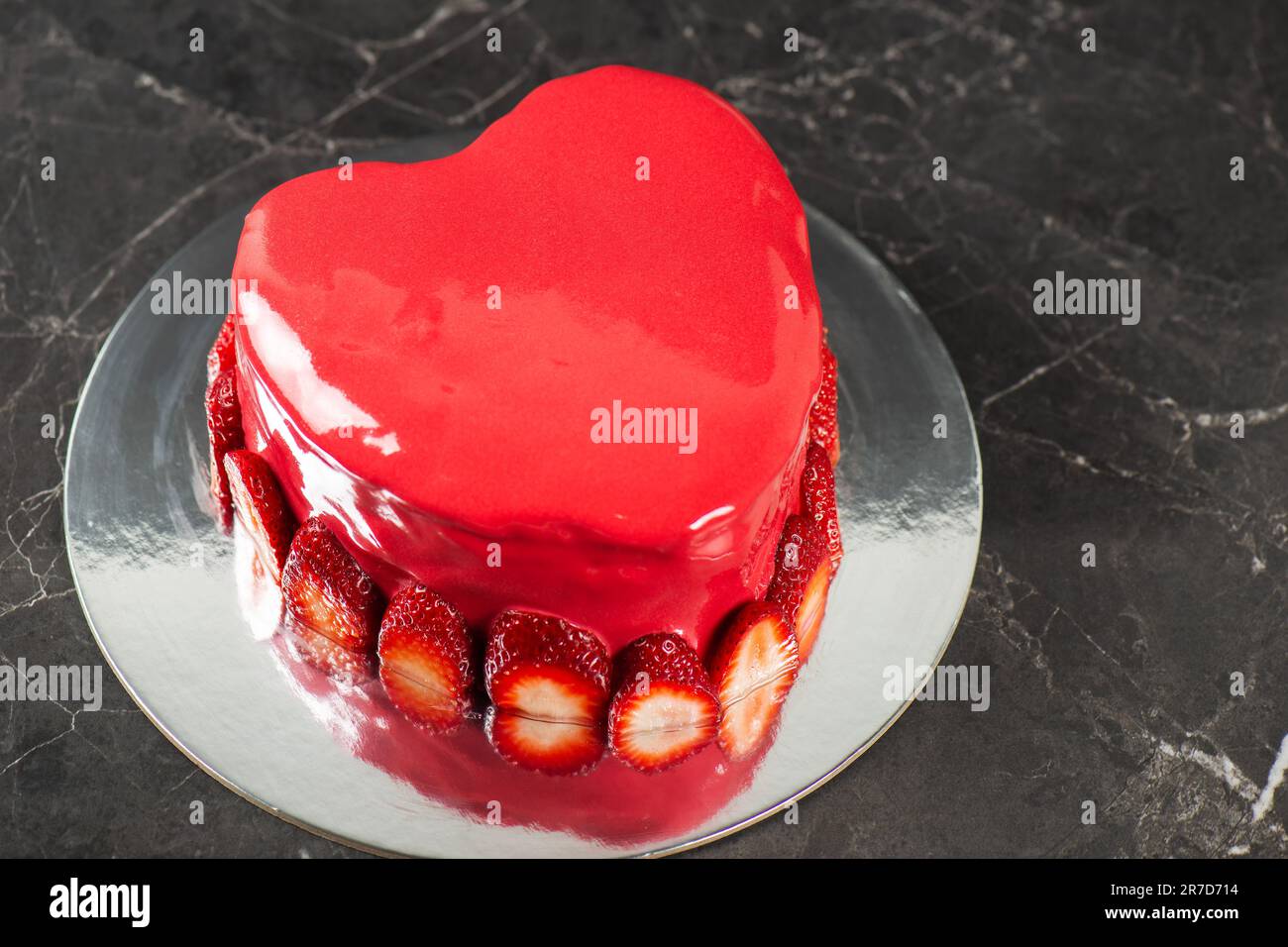 Beautiful heart-shaped moist mud cake with a ganache coating, red ...