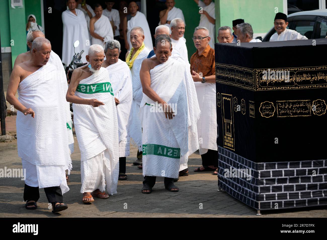 Husin bin Nisan, second left, walks with other worshippers to circle a ...