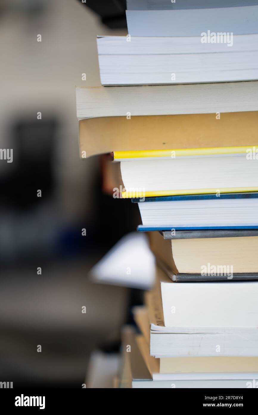 Stack of books in a library to read Stock Photo - Alamy