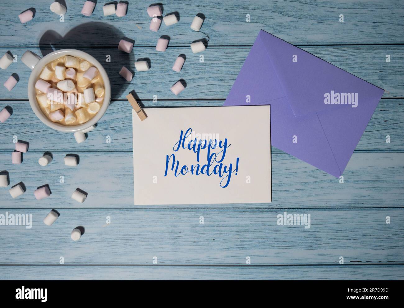 HAPPY MONDAY blue Monday concept text violet envelope with white cup of ...