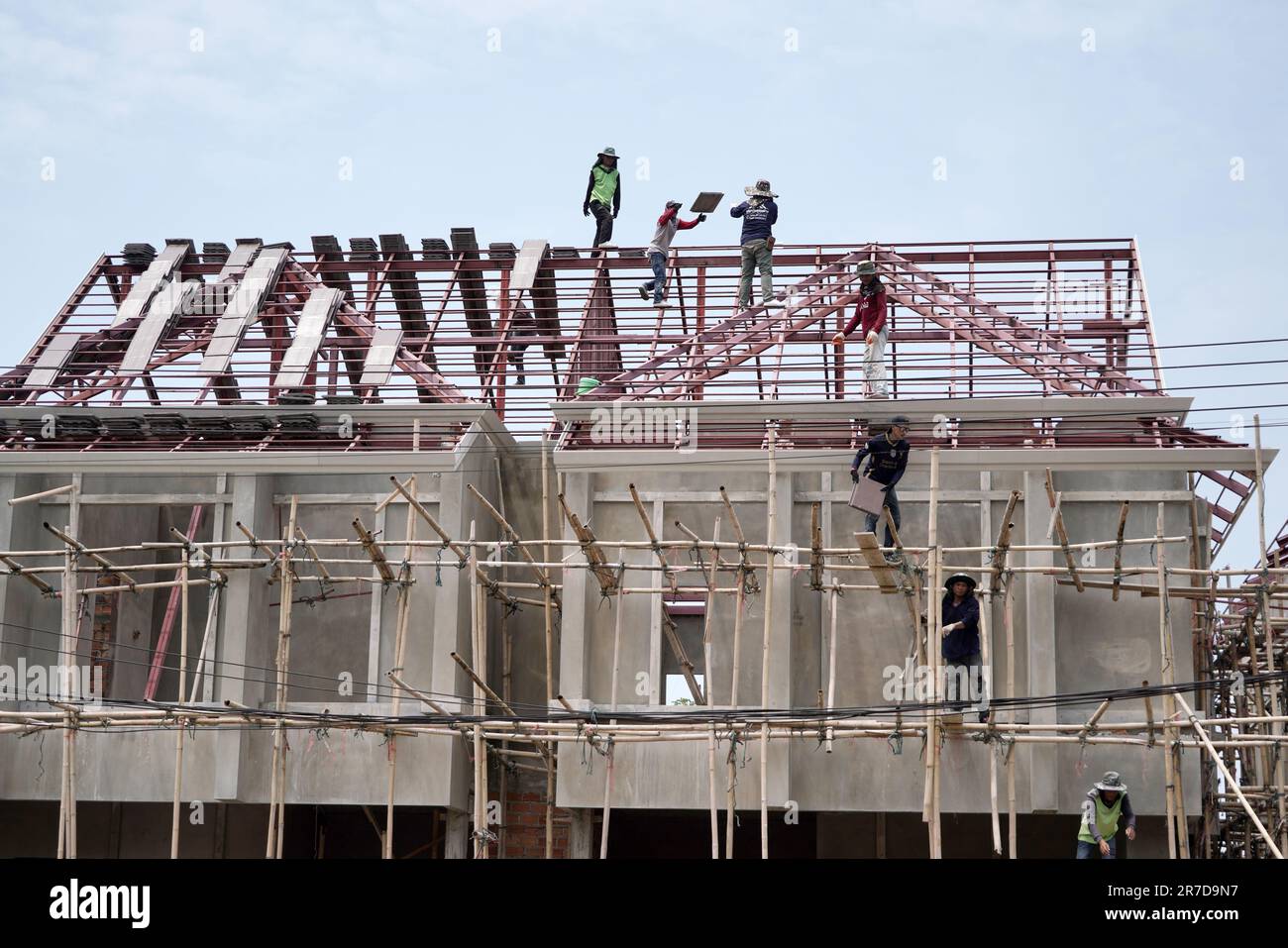The Roofer working on roof structure of building on real estate ...