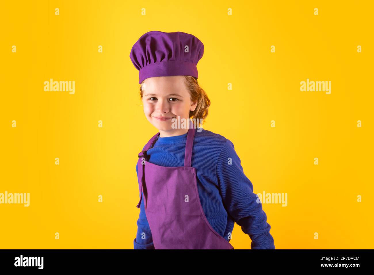 Chef kid boy making healthy food. Portrait of little child in chef hat ...