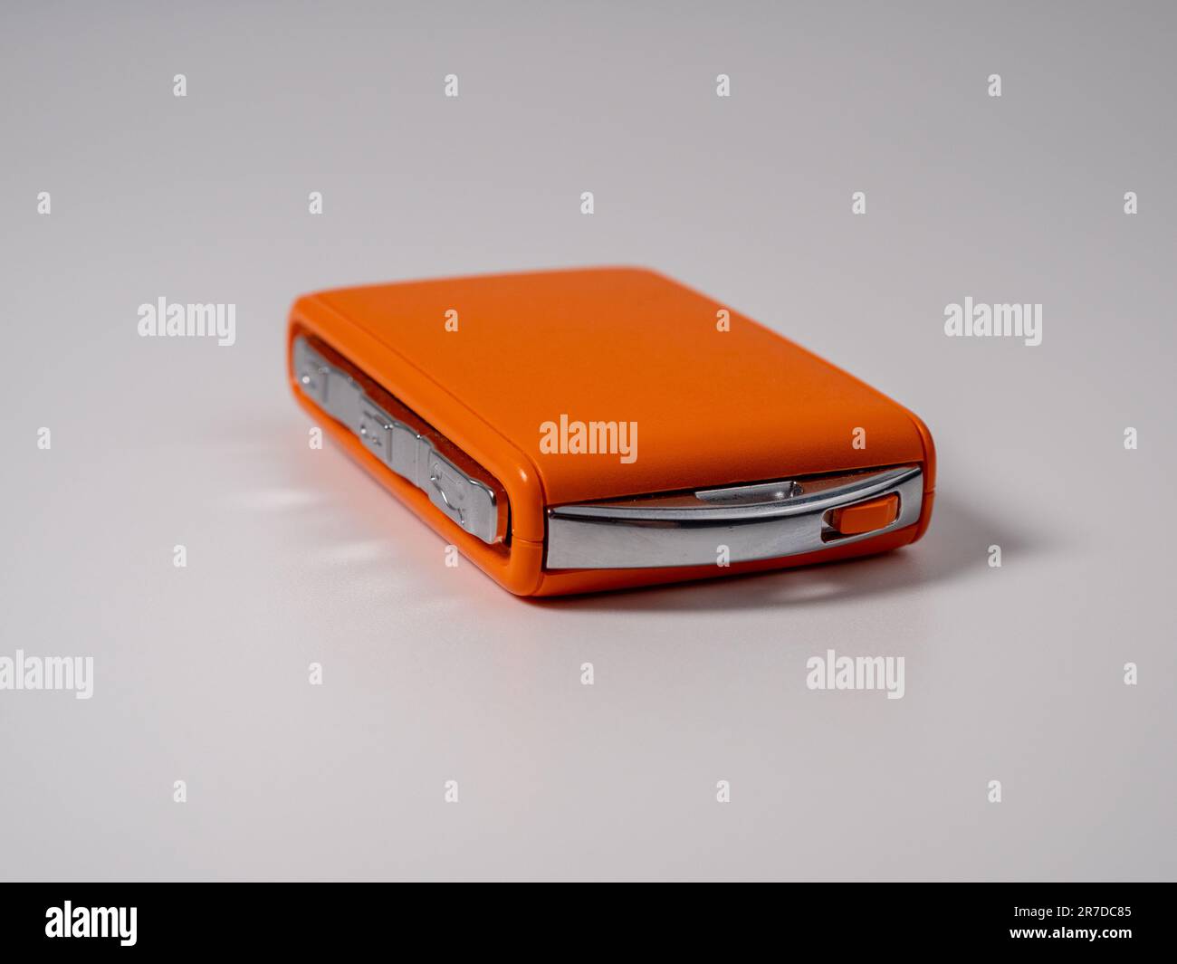 Modern wireless orange car ignition key on a white background. Wireless ...