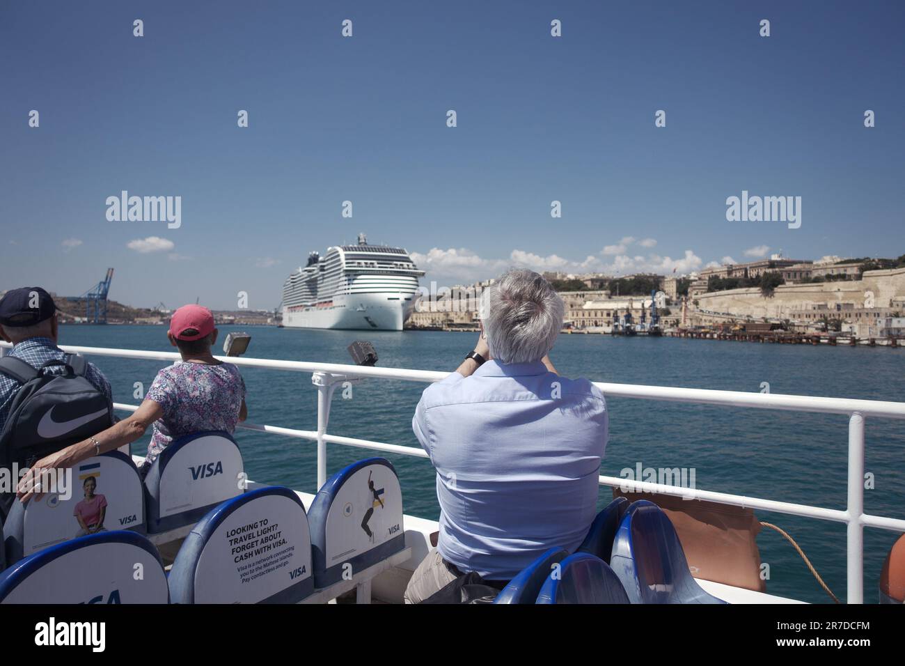 man taking a picture from Lascaris ferry on Grand Harbour with cruise ...