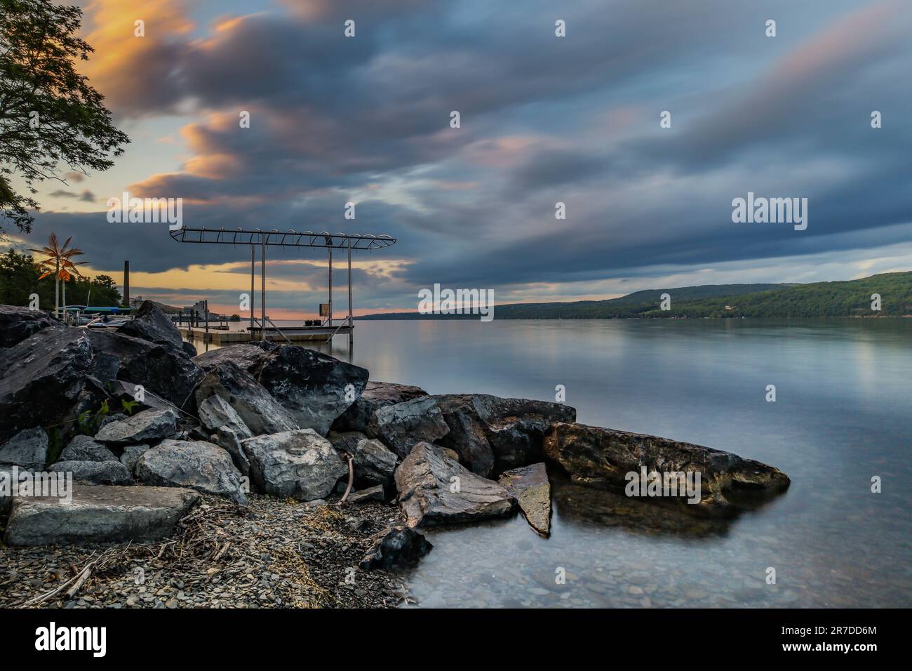 A scenic view of a riverbank, with large rocks and stones scattered ...