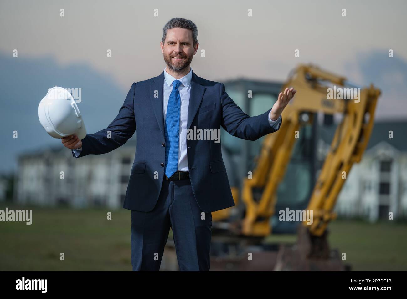 Construction business owner. Man in suit and hardhat halmet at building ...