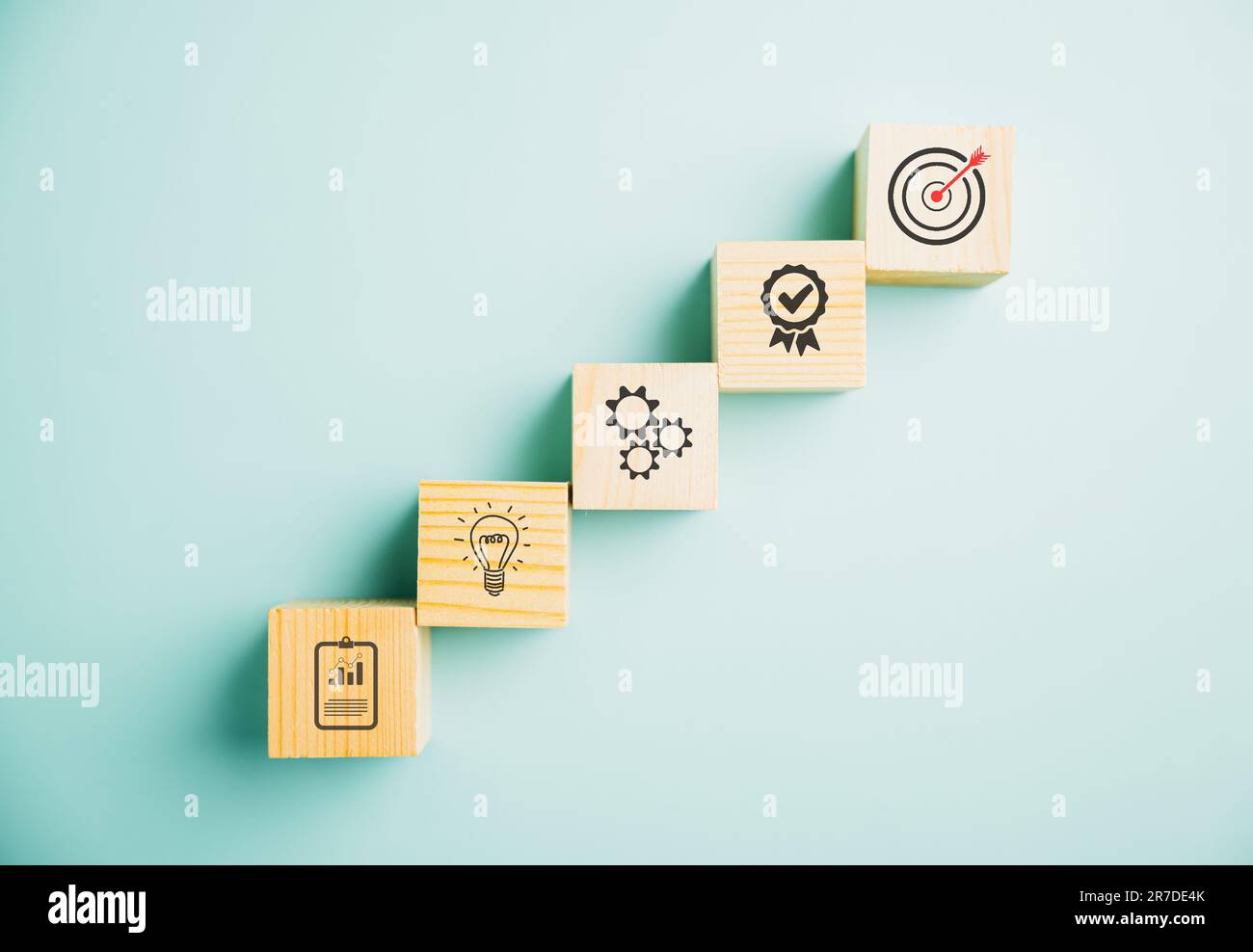 Wooden block cude step on table with Action Plan Stock Photo - Alamy