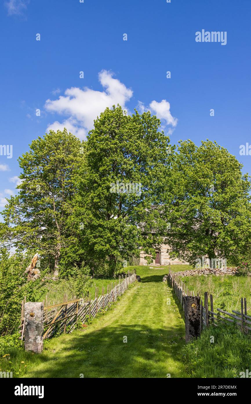 Wooden fence to an old church in a beautiful summer landscape Stock ...