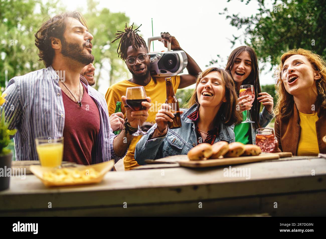 A diverse group of friends having a great time at an outdoor bar ...