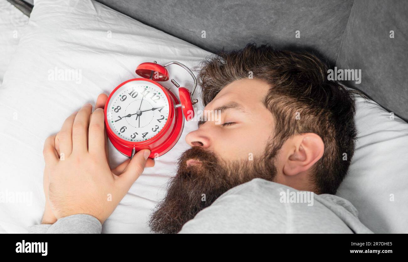 Portrait of man sleeping with alarm clock in bed, sleep time Stock ...