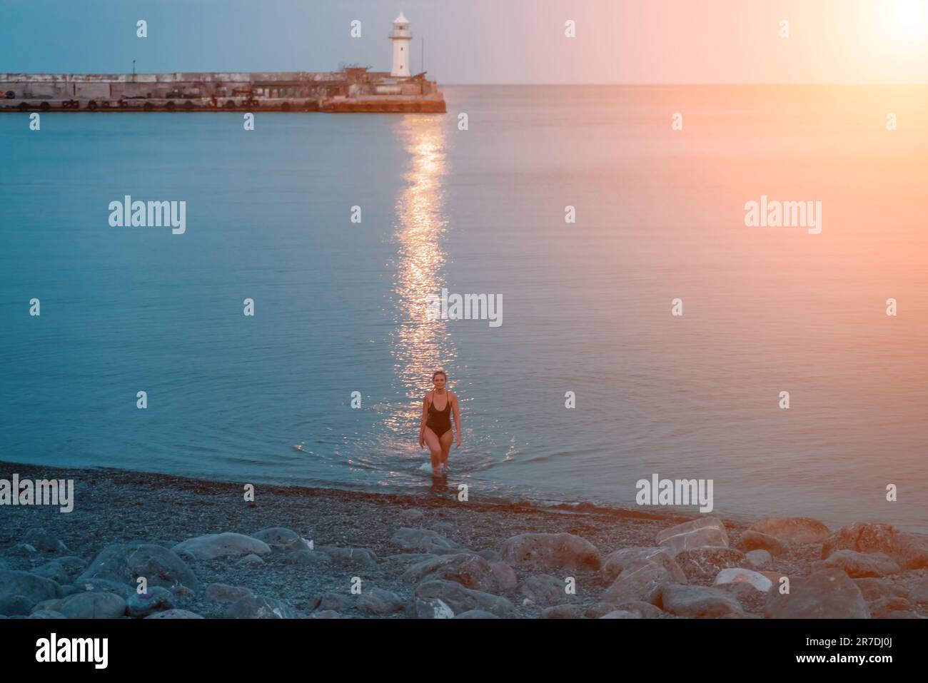 Woman The full moon rises to the lighthouse, the lunar path along the ...