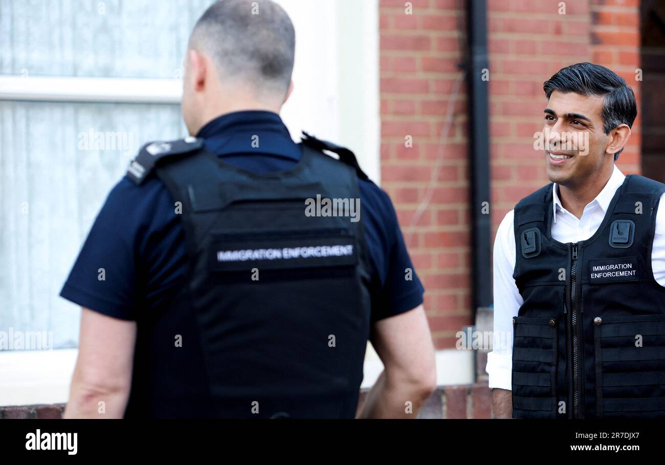 Britain's Prime Minister Rishi Sunak observes an immigration visit, in ...