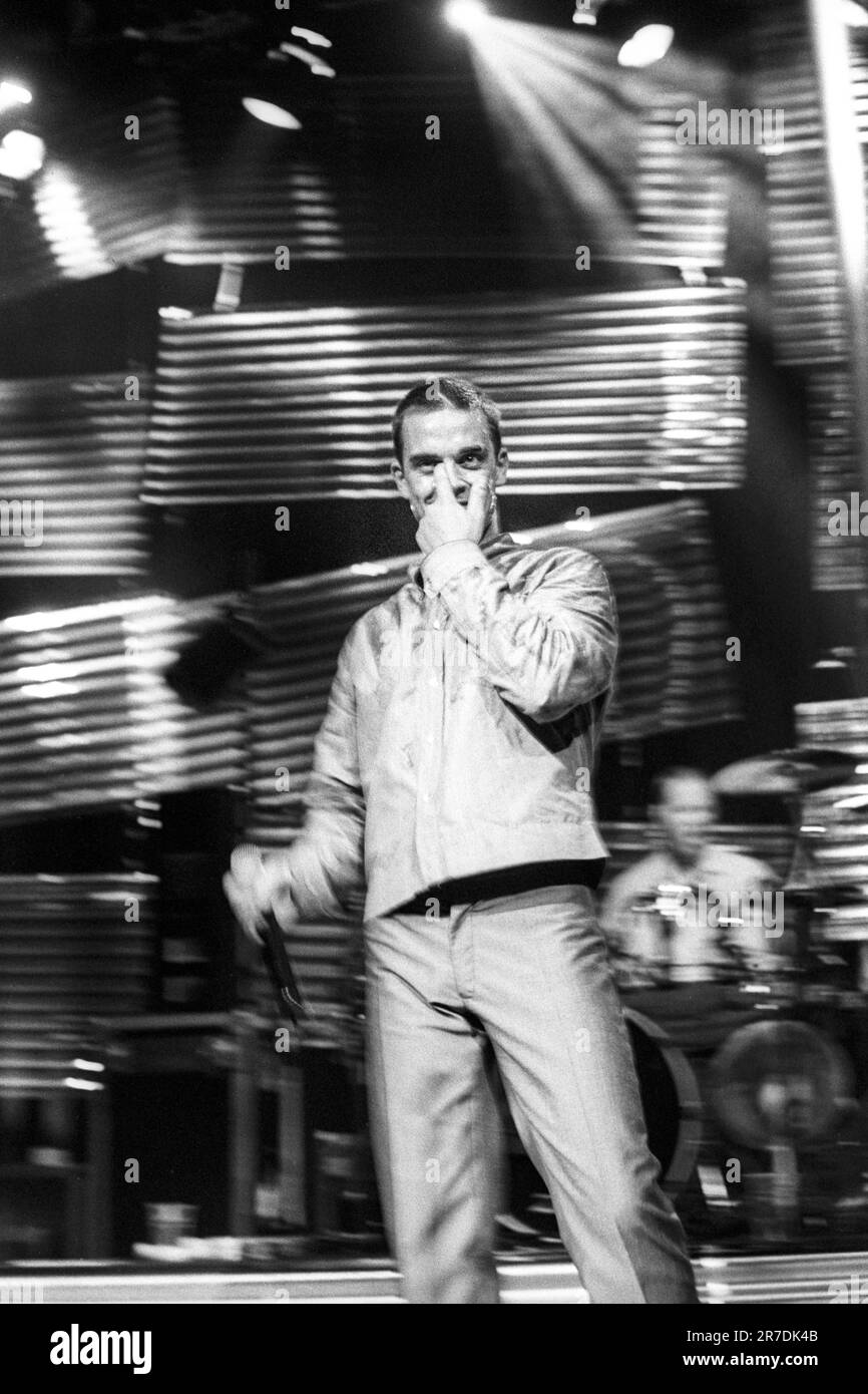 ROBBIE WILLIAMS, SINGER, FIRST TOUR, 1997: Robbie Williams playing live ...