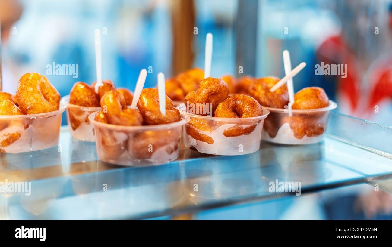 View of lokma, traditional deep fried Turkish dessert street food on a ...