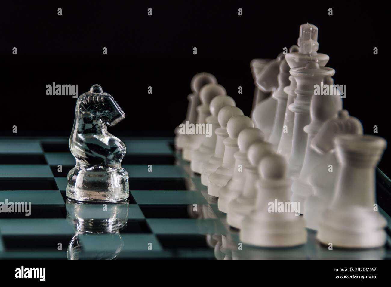 A transparent knight chess piece on a chessboard, with the white pieces ...