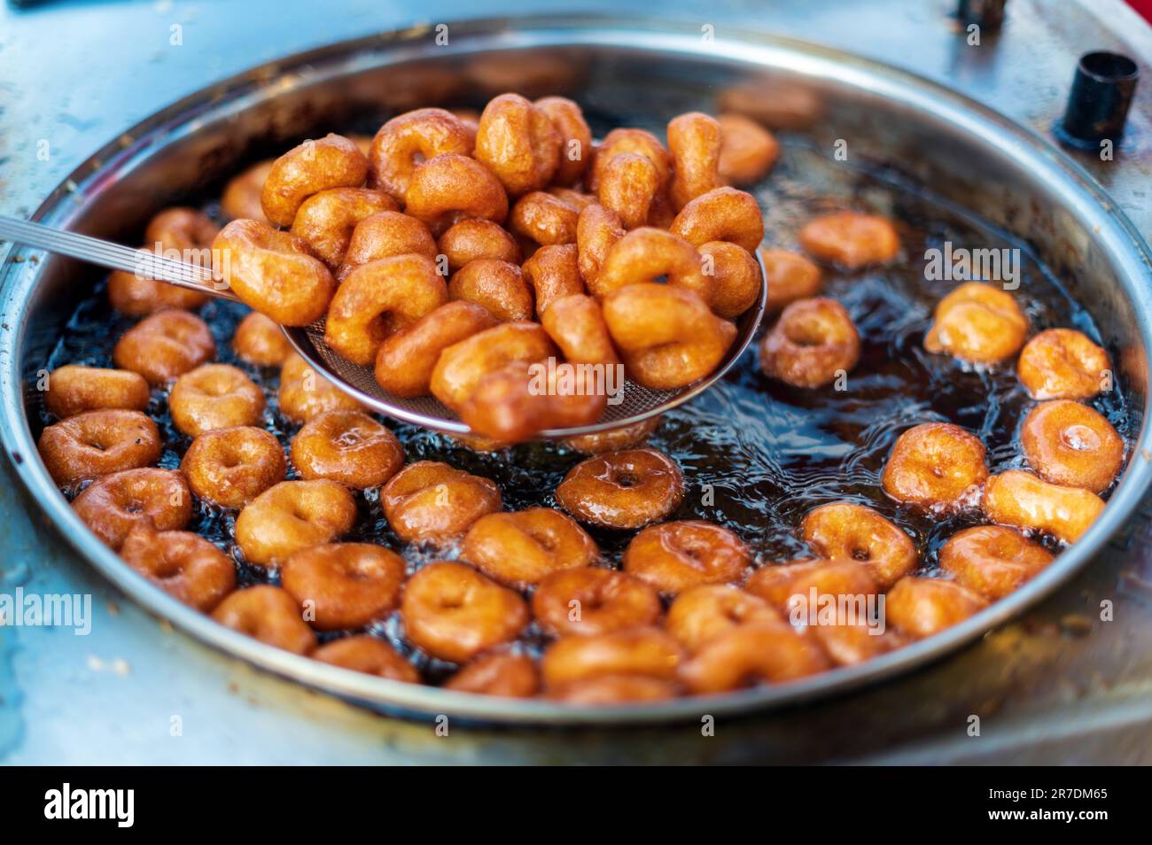 Deep fry of the traditional dessert lokma in Istanbul, Turkey Stock ...