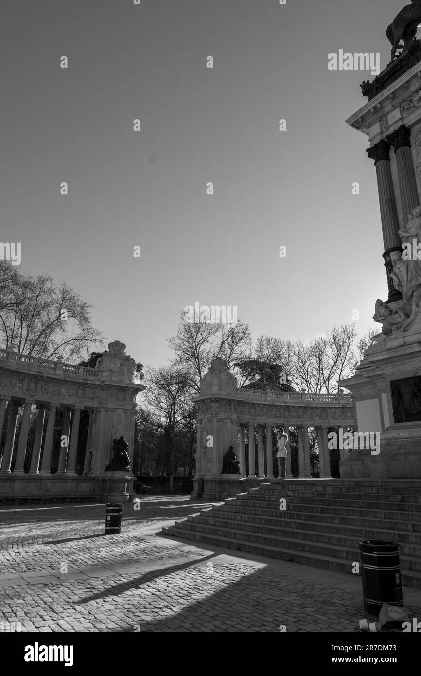 An architectural stone facade featuring a central monument surrounded ...