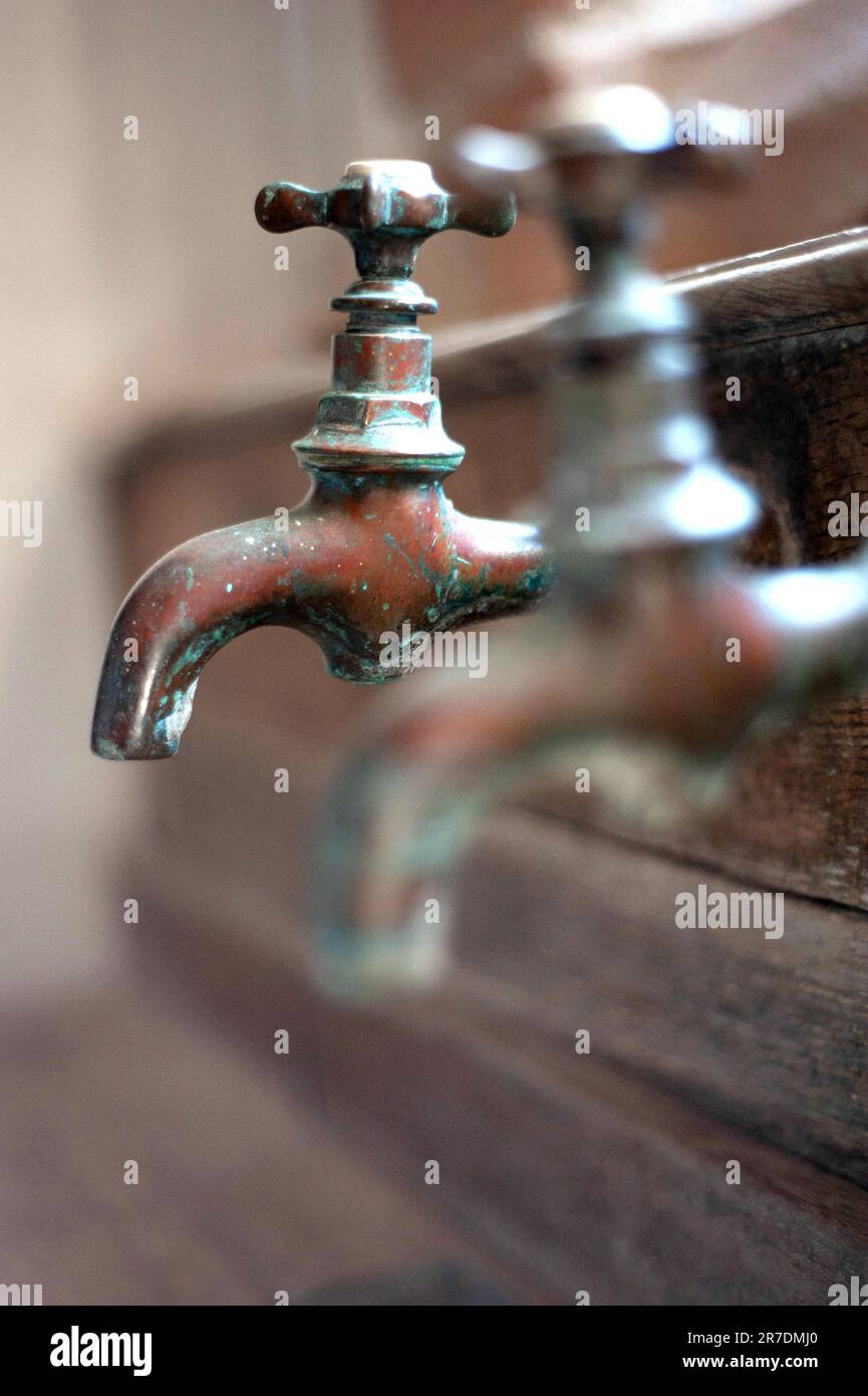 Two old brass taps Stock Photo - Alamy