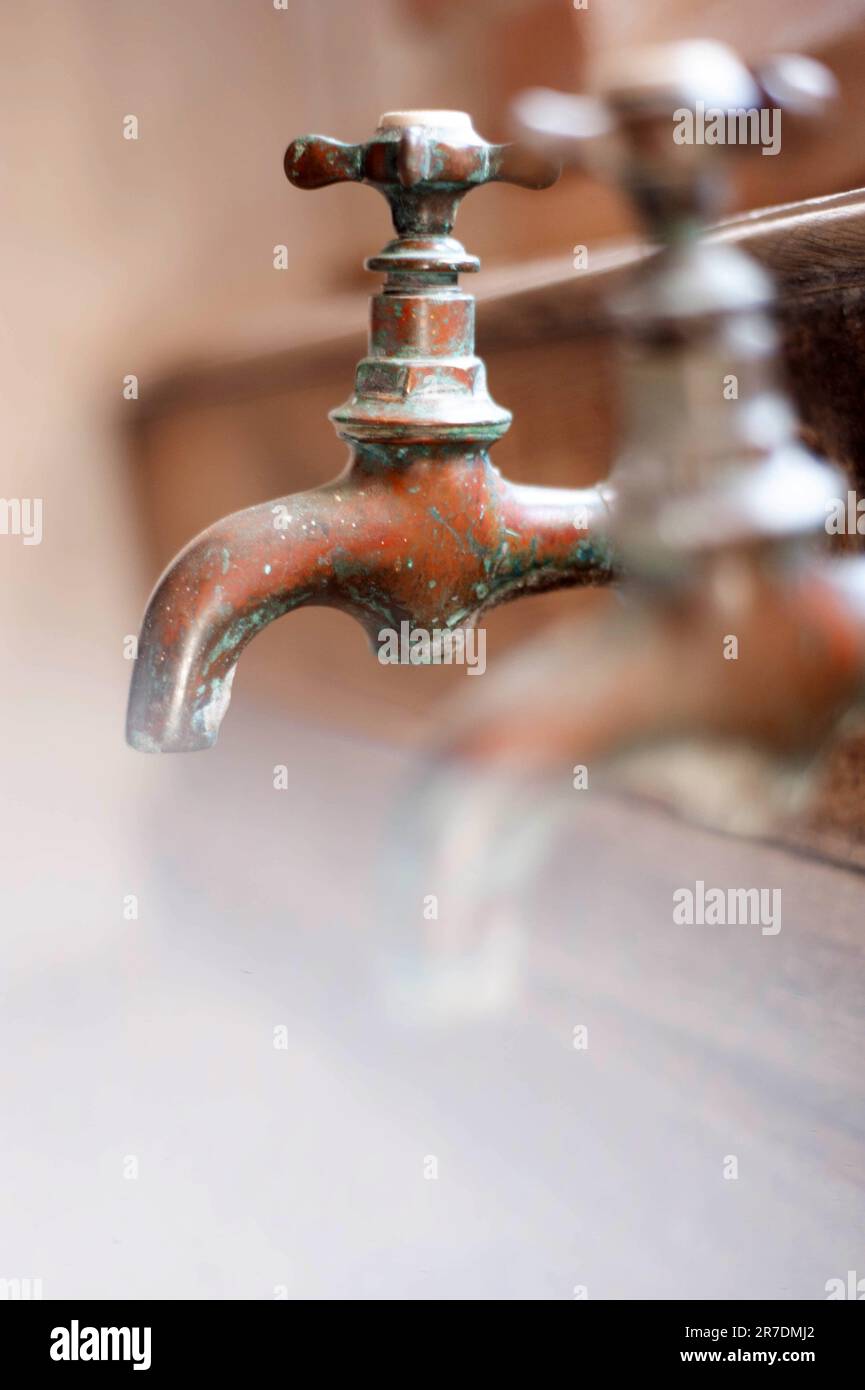 Two old brass taps Stock Photo - Alamy
