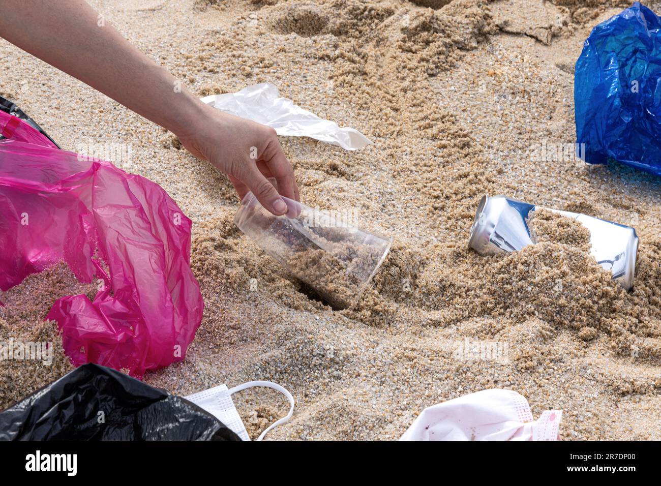 Plastic waste beach hands hi-res stock photography and images - Alamy