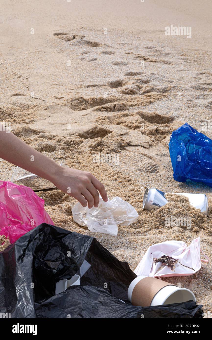 Plastic waste beach hands hi-res stock photography and images - Alamy