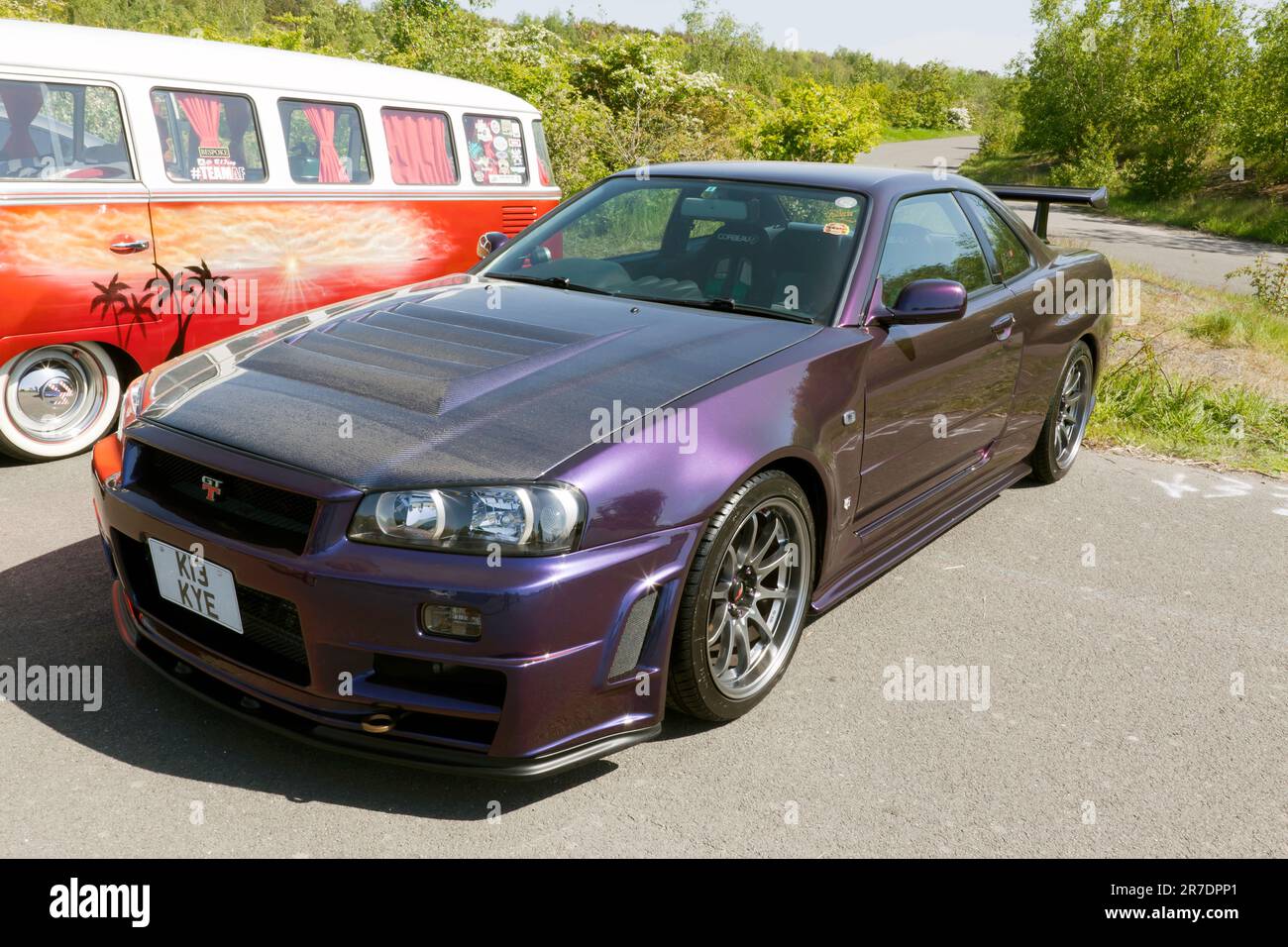 Three-quarters front view of a Purple, 2000, Nissan R34 Skyline GT-T ...