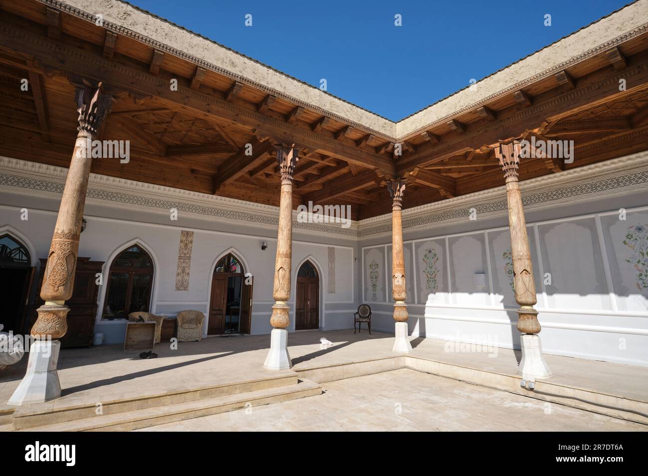 The white courtyard with wood carved columns. At the Kokand Khan house ...