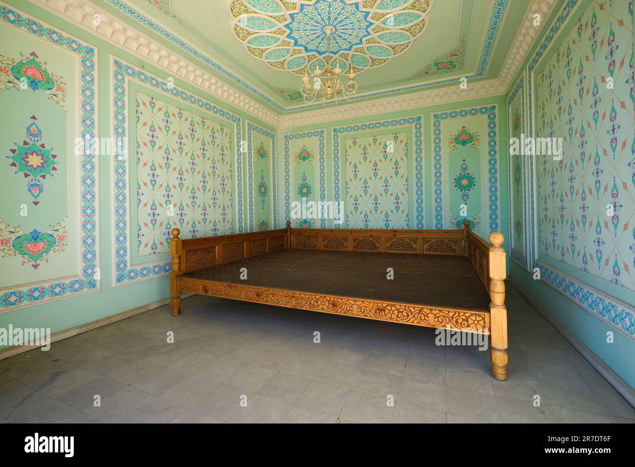 A green alcove with a large, wood, traditional tapchan. At the Kokand ...