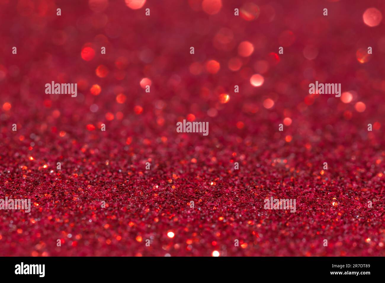 Defocused red glitter background.Shiny red background .Christmas card ...