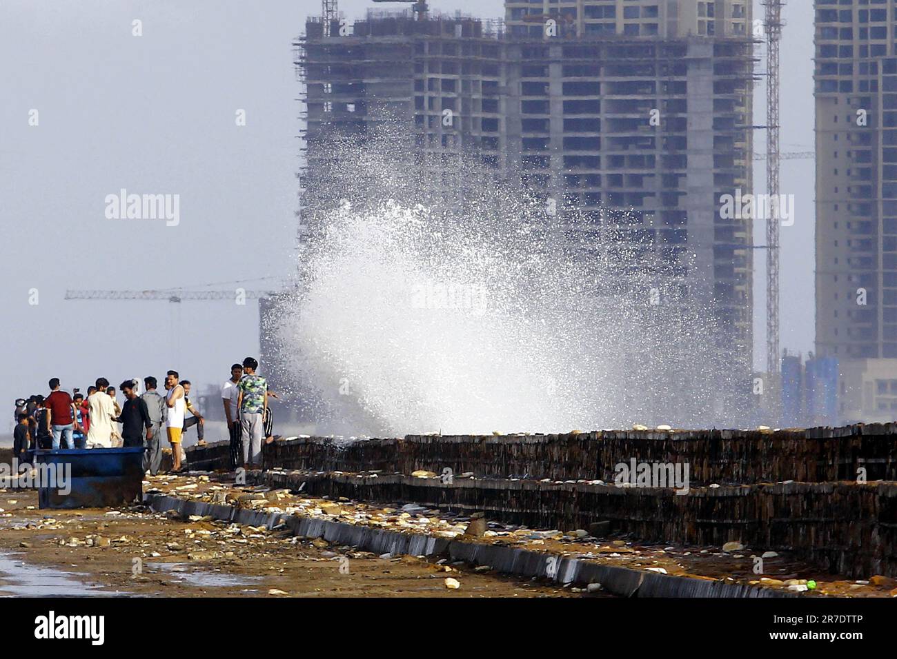 Karachi. 14th June, 2023. People view high tides at a beach ahead of ...