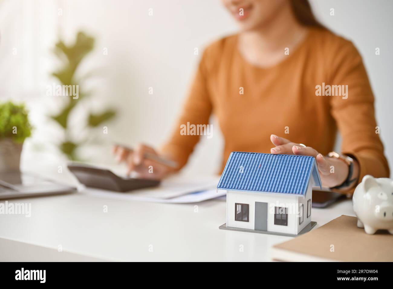 Close-up image of a female real estate agent working at her desk ...
