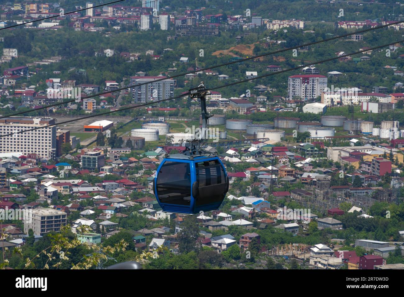 Close-up of an empty cab on a cable car over the city and mountains ...