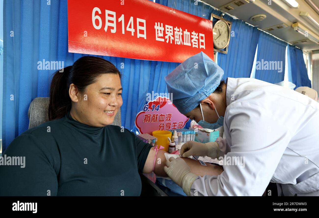 People donate blood at a blood donation center on the 20th World Blood ...