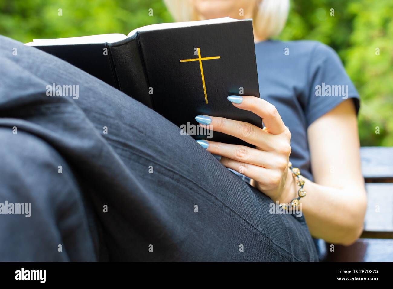 woman reading the bible sitting on a bench. woman reading the bible on ...