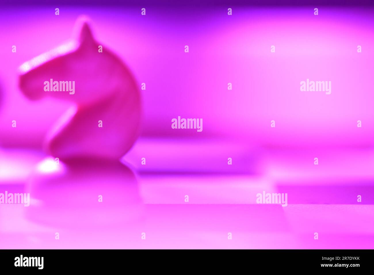 Abstract pink background. Blurred background with a chess piece ...
