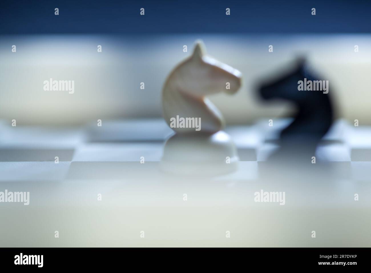Blurred background with chess pieces. White and black chess pieces of ...