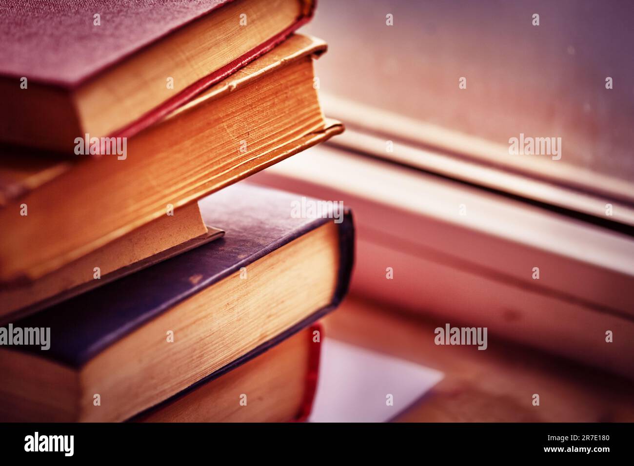Old books on the windowsill. Background from old books, a stack of old ...