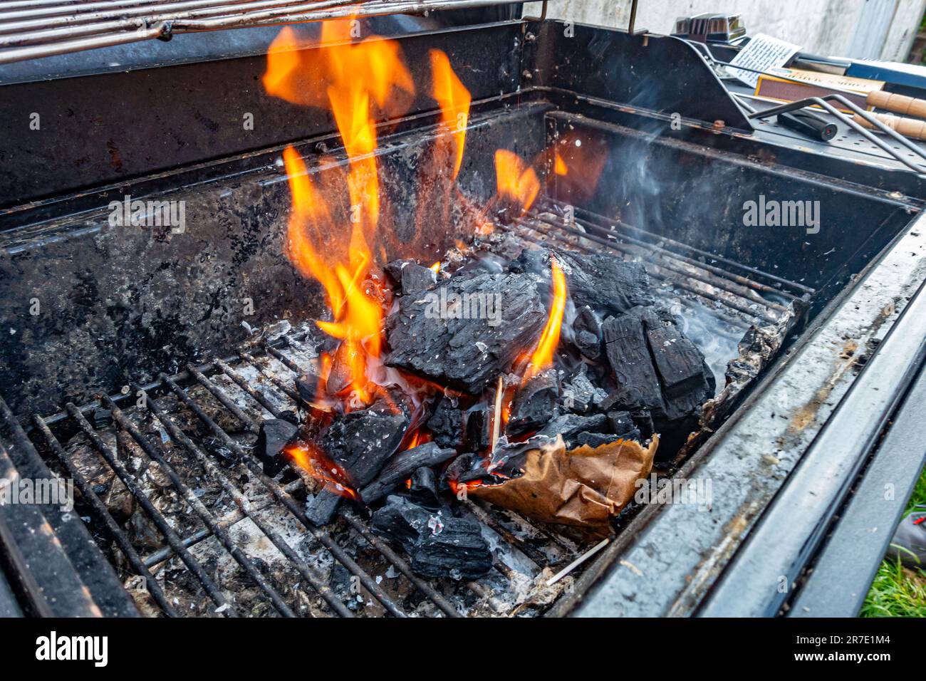 Charcoal burning in a barbecue in readiness to cook Stock Photo - Alamy