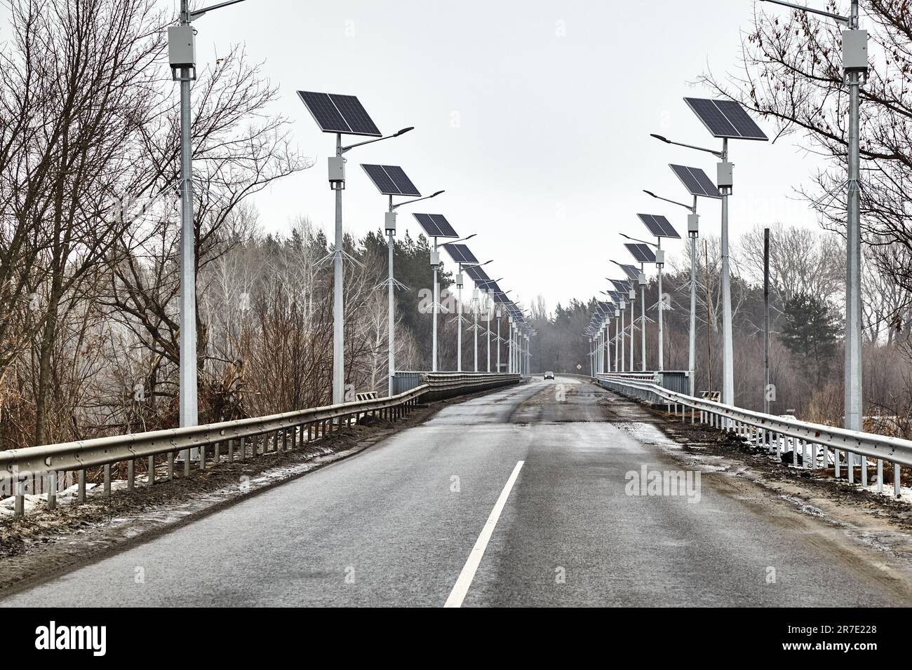 Asphalt road on the bridge. Solar bridge road lighting. Landscape with ...