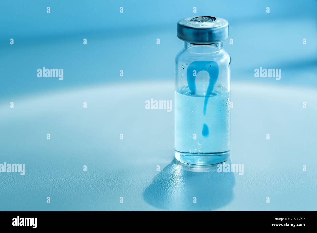 Medical ampoule on a blue background. Vaccination concept. Question ...