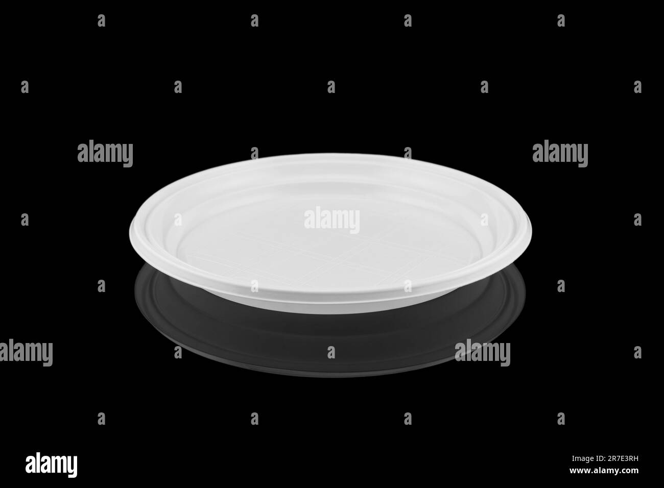 Disposable white plastic plate isolated on black background Stock Photo ...