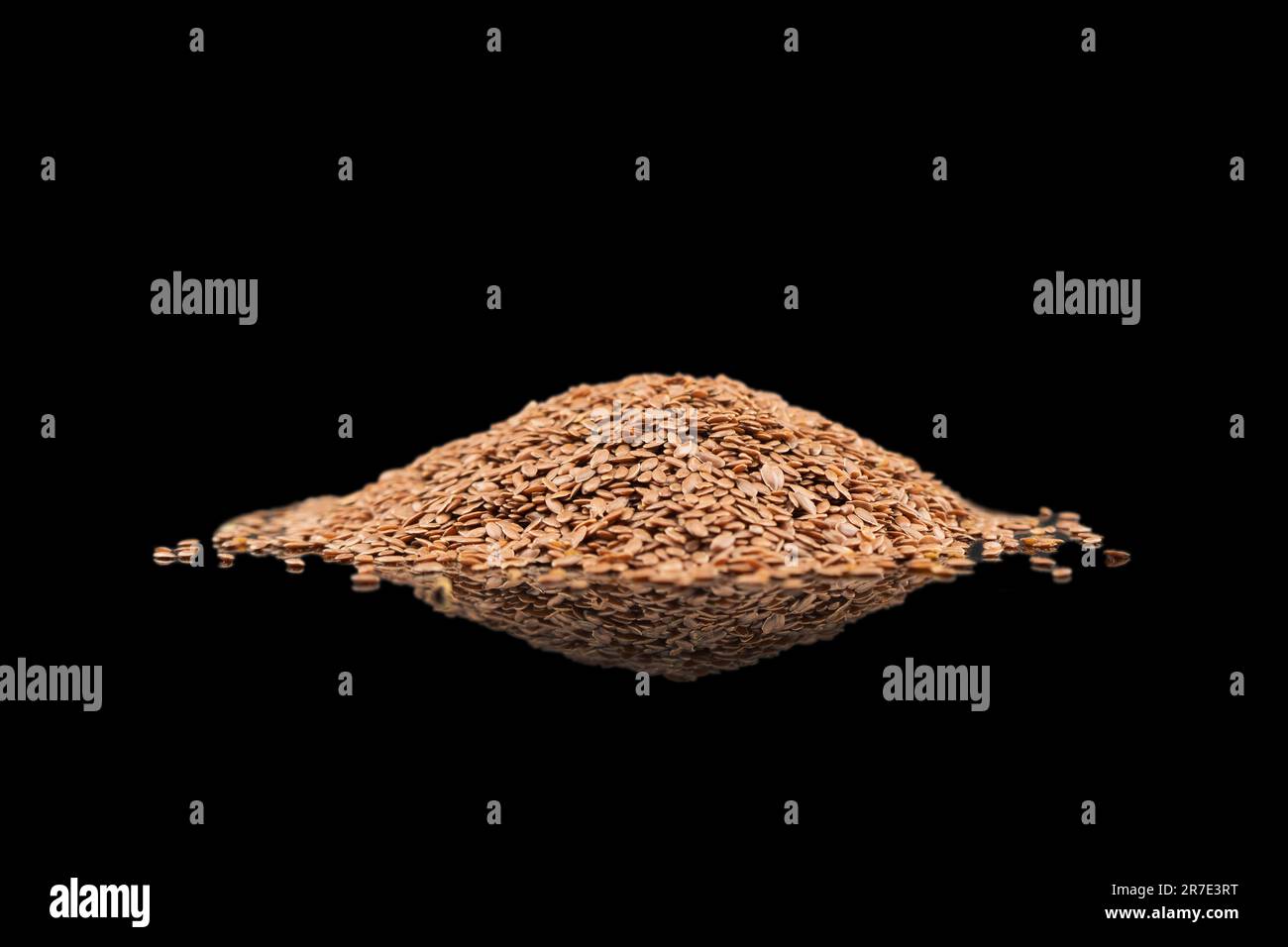 Linseeds. Flax seeds isolated on black background. Flax seed heap ...