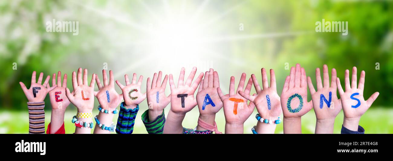 Children Hands Building Word Felicitations, Grass Meadow Stock Photo ...