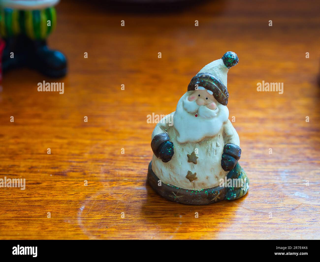 A traditional white Father Christmas figurine showing his pokey red ...