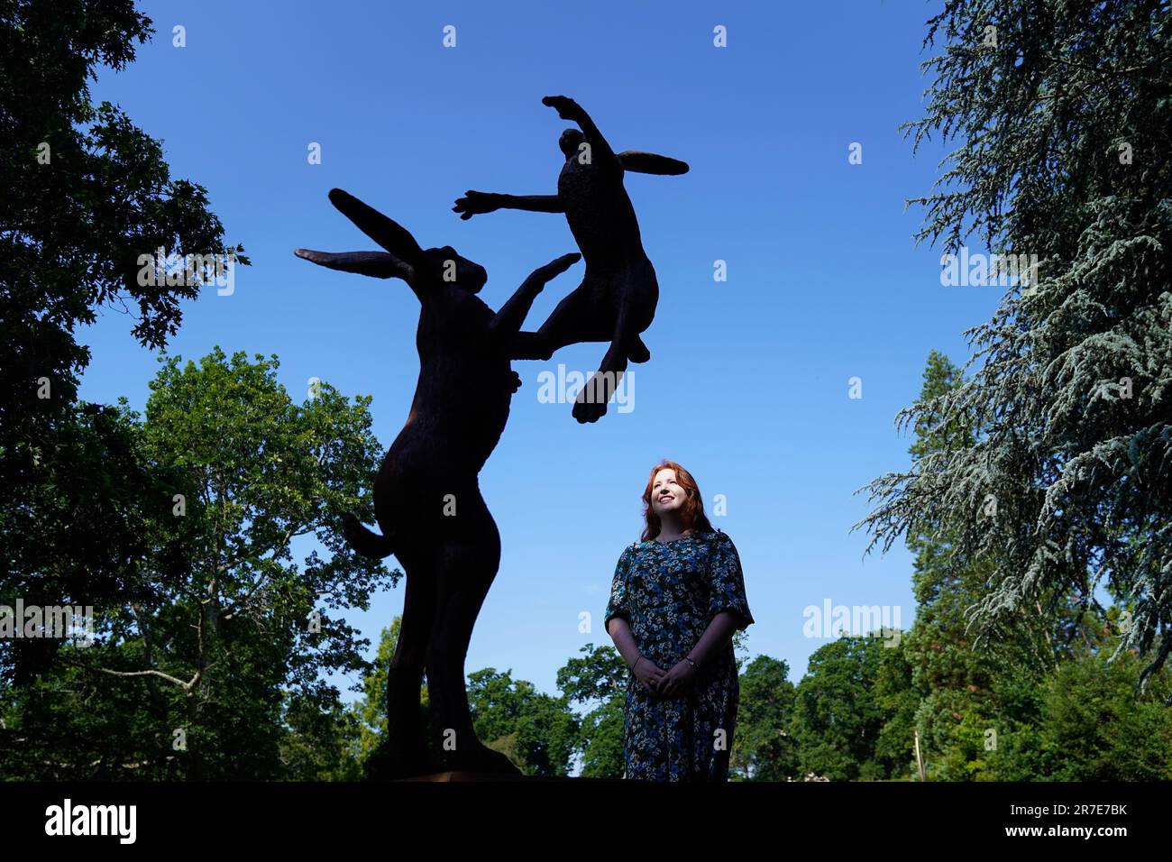 A person looks up at the sculpture 'Large Boxing Hares' by artist ...