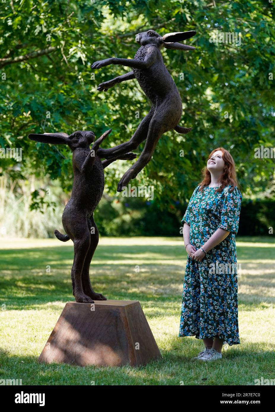 A person looks up at the sculpture 'Large Boxing Hares' by artist ...