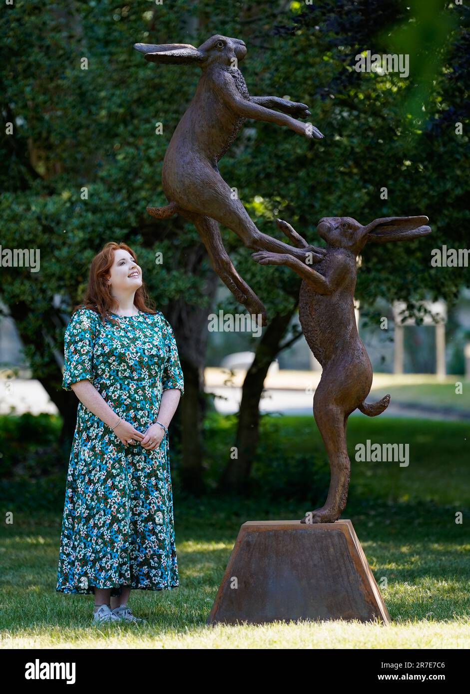 A person looks up at the sculpture 'Large Boxing Hares' by artist ...