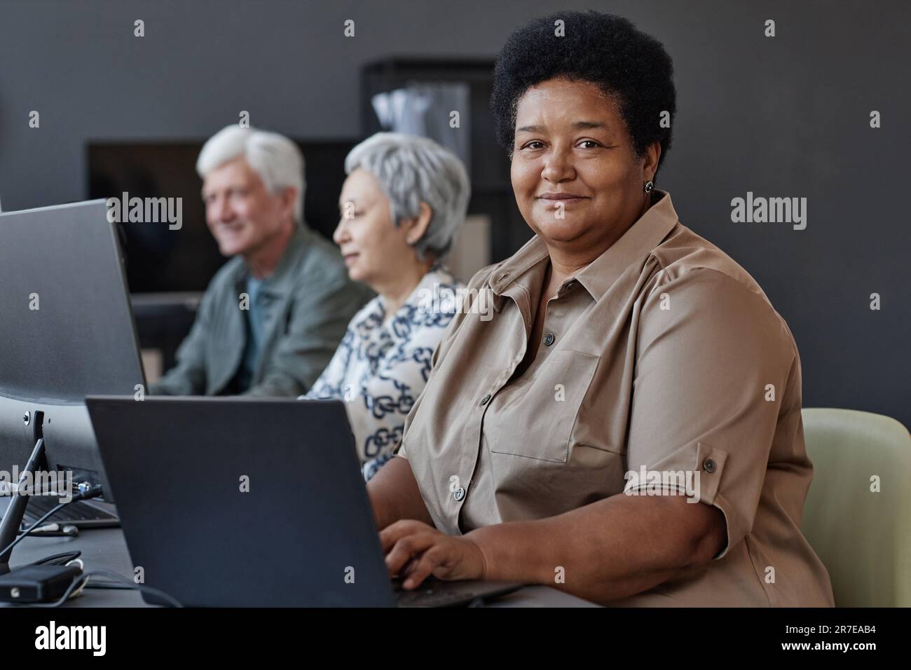 Portrait of black senior woman in computer class for elderly smiling at ...