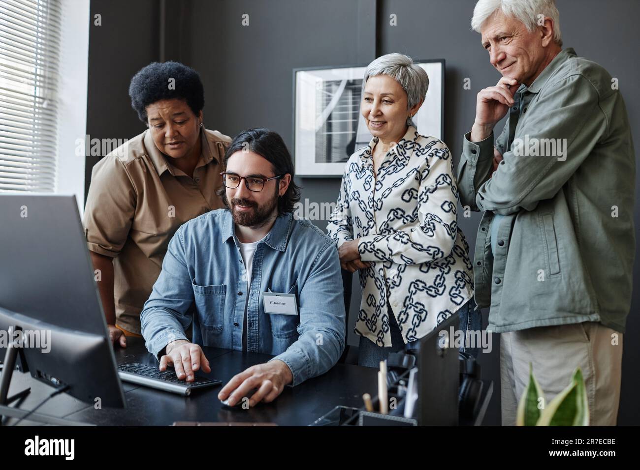 Diverse group of smiling senior people watching man explaining ...