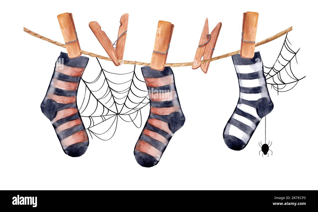 Watercolor striped socks are dried on a rope. Wooden clothespins ...